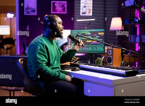 Artist Composer Recording A New Track On His Home Studio Microphone Editing His Song With