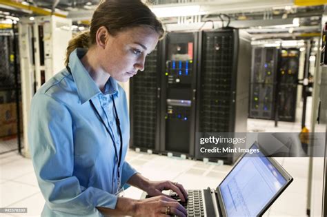 Caucasian Woman Technician Running Diagnostics On Computer Servers In A