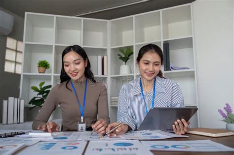 Two Business Professional Discussing Planning And Analysis In A Modern