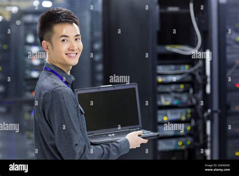 Technician Using Laptop In Computer Room Stock Photo Alamy
