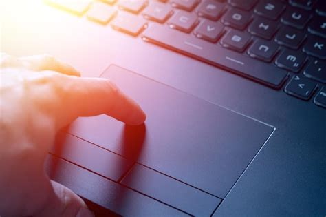 Premium Photo Hands Are Using A Touchpad Of Laptop Close Up Picture And Sunshine