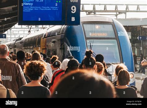 A Train Pulls Into A Crowded Platform At Luxembourg Railway Station On