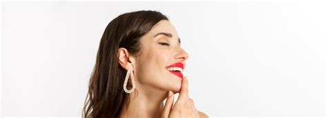 Premium Photo Close Up Of Young Woman Applying Lipstick Against White