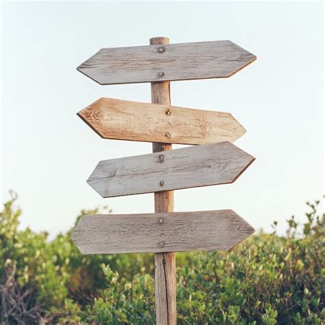 Wooden Signpost On The Beach Concept Of Direction Navigation Premium Ai Generated Image