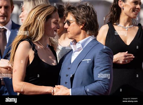 A Glance Between Rebecca Ferguson And Tom Cruise During The Red Carpet At The Global Premiere