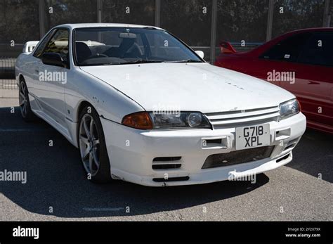 Front View Of A White Eighth Generation Nissan Skyline Gt R32 At A