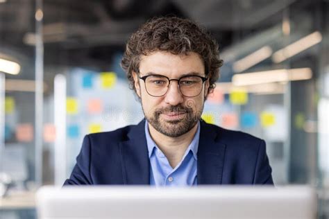 Business Professional Working On Laptop In Modern Office Space Stock