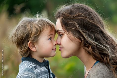 Affectionate Mother Touching Noses With Her Young Son Affectionate Mother Touches Noses With