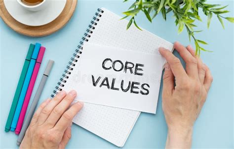 Notebook With Text Inside Core Values On Table With Coffee Laptop And Some Sheet Of Papers With