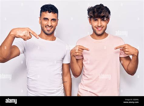 Young Gay Couple Wearing Casual Clothes Looking Confident With Smile On