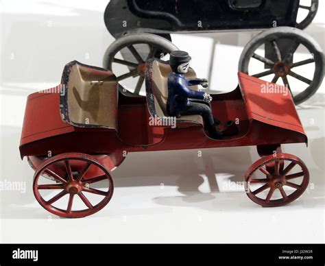 A Photograph Of A Vintage Tin Toy Car Displayed At The Louwman Museum
