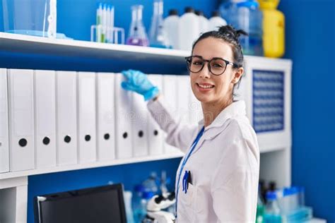 Young Caucasian Woman Scientist Smiling Confident Holding Binder Of