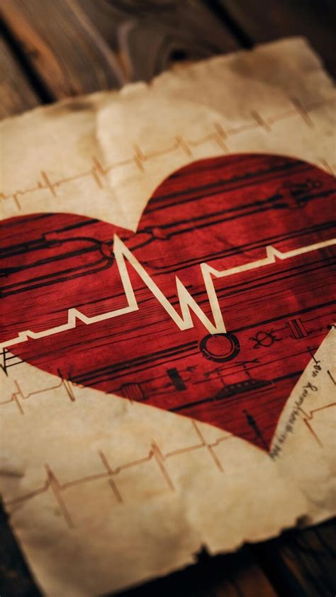 Close Up Of An Electrocardiogram In Paper Form Vith Red Wooden Heart
