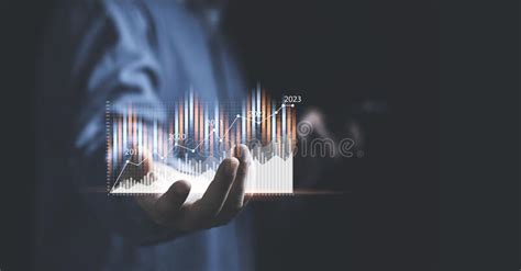 Businessman Holding Virtual Technical Graph And Chart For Analysis