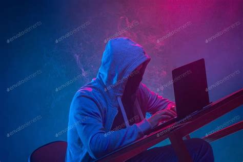 Hooded Computer Hacker Stealing Information With Laptop By Master1305
