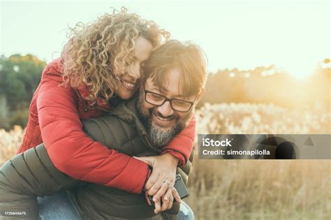 Young Adult Mature Couple In Love Hugging And Smiling With Romance