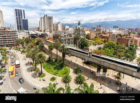 Medellin Skyline With Metro De Medellín Train At Plaza Botero Square In