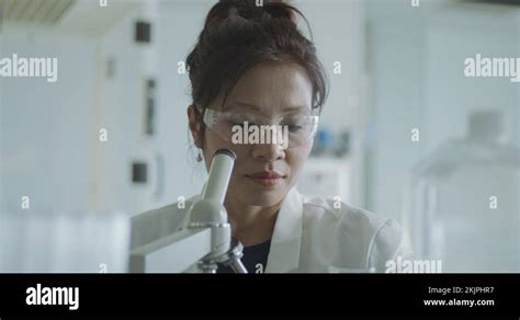 Asian Female Laboratory Scientist Conducts Experiment In Science Lab With Stock Video Footage