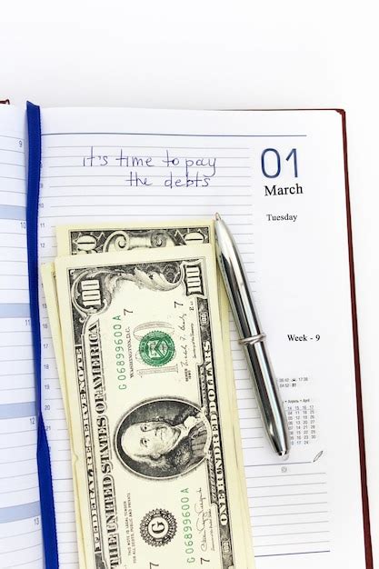 Premium Photo Writing Down In A Notebook About A Debt