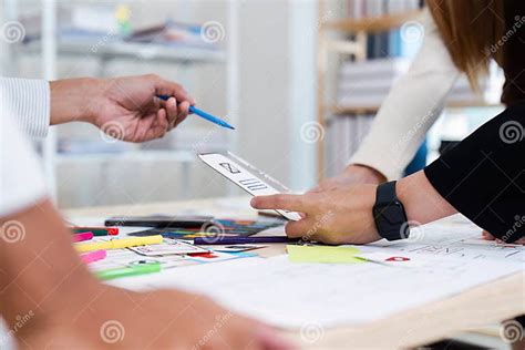 Creative Team Collaborating On Ux Ui Design Project With Wireframes And Prototypes Stock Image