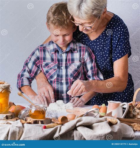 Grandmother With Grandson Cooking Kneading Dough Baking In The