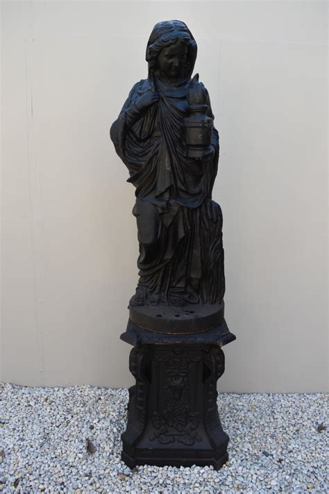 Lot A Large Cast Iron Statue Depicting One Of The 4 Seasons Winter
