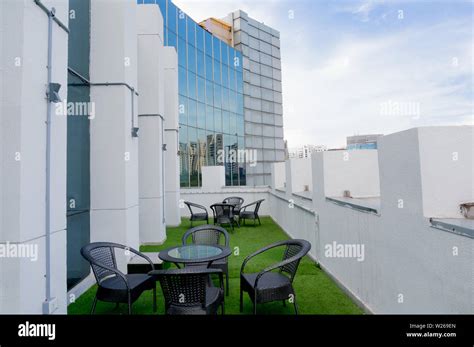 Outdoor Seating Space In A Building With Artificial Grass And Seats
