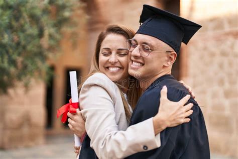 Man And Woman Mother And Son Hugging Each Other Celebrating Graduation