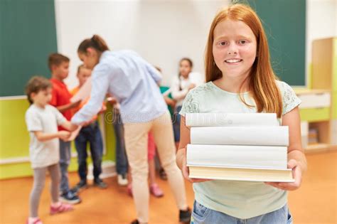 Smiling Redhead Schoolgirl Holding Stack Of Books Stock Image Image Of People Elementary