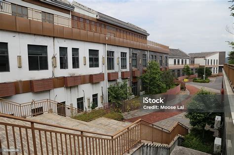 A Twostory School Building With Lightcolored Brick And Wood Exterior