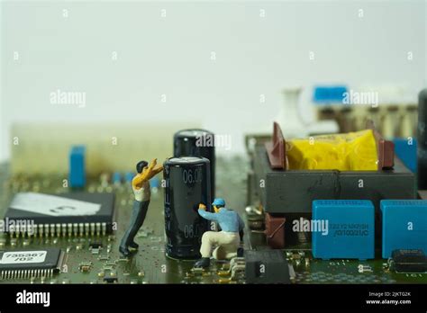 Two Workers Inspect Components On An Electronic Circuit Board Stock Photo Alamy