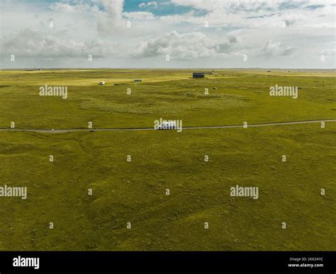 An Aerial View Of The Green Landscape Stretching Toward The Horizon On