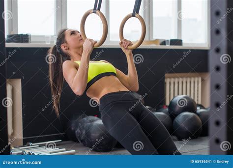 Fit Woman Going Pull Ups With Gymnastic Rings In Gym Stock Image