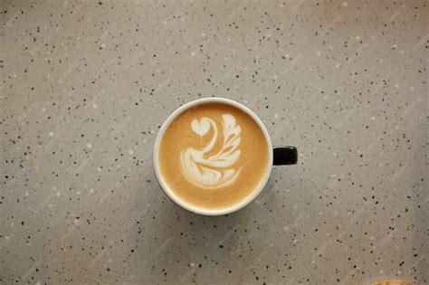 Premium Photo Top Down View At One Cup Of Coffee With Latte Art On