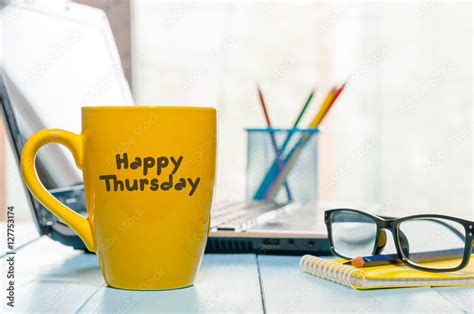 Happy Thursday Word On Coffee Cup At Blurred Blue Wooden Background