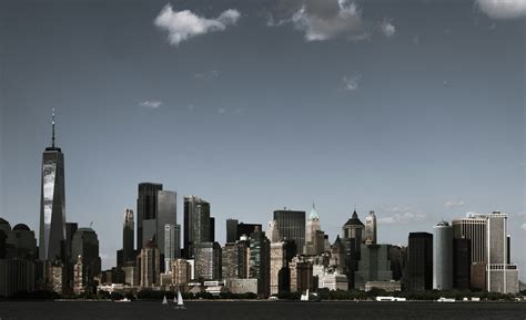 A City Skyline With A Sailboat In The Foreground Photo Free Usa Image