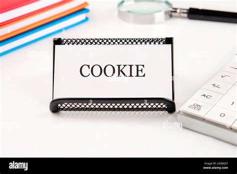 A Neatly Arranged Workspace Features A Card Labeled Cookie A Calculator A Magnifying Glass