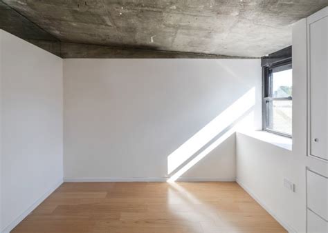 House By Tectum Features Raw Concrete Walls And Black Metal