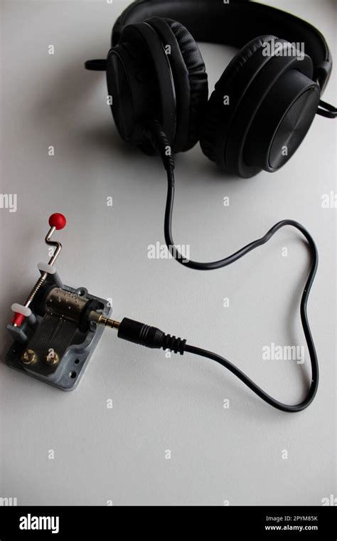 Black Cable With Jack Plugin Connects Plastic Headset And Iron Crank