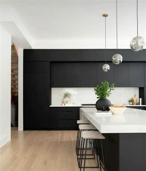 Modern Kitchen With Black Cabinets And White Countertops