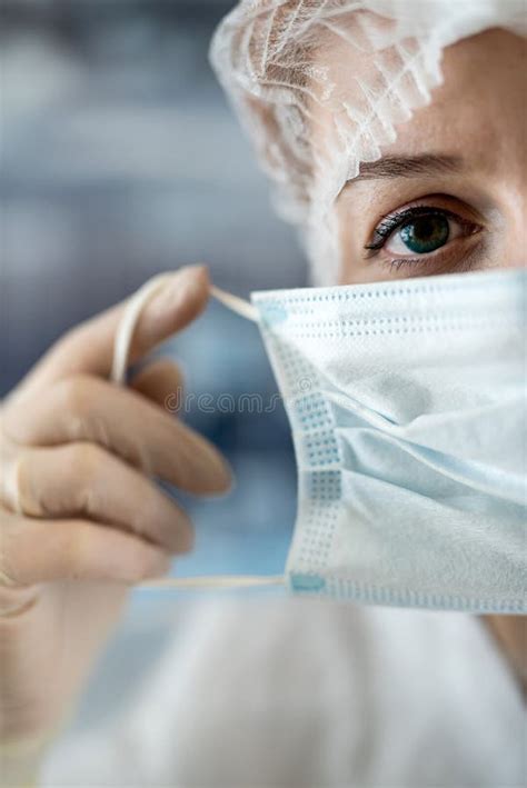 Young Female Nurse Putting Her Medical Mask At Surgery Stock Image