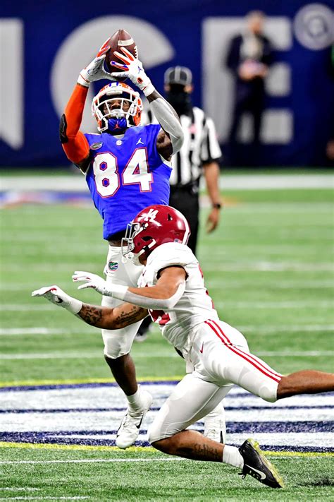 Download Kyle Pitts Catching Football During Game Wallpaper