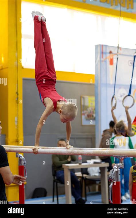 Gymnast Exercise Parallel Bars In Championship Gymnastics Boy