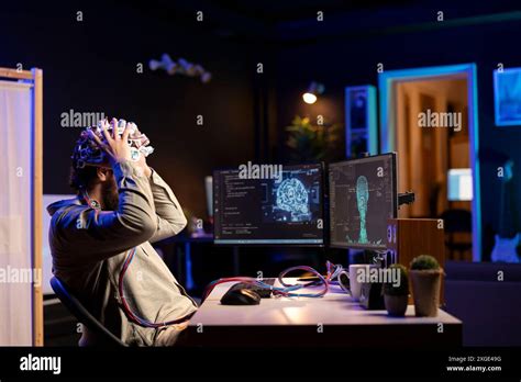 computer scientist placing eeg headset on head to communicate with