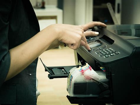 Premium Photo Midsection Of Woman Using Computer Printer