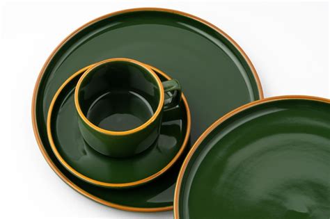 Premium Photo A Set Of Dark Green Ceramic Tableware With Orange