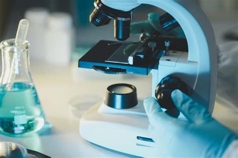 Premium Photo Female Medic In Uniform Working With Microscope Making