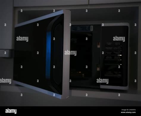 Microwave Oven Door And Prepare Food In The Microwave Dark Tone Stock