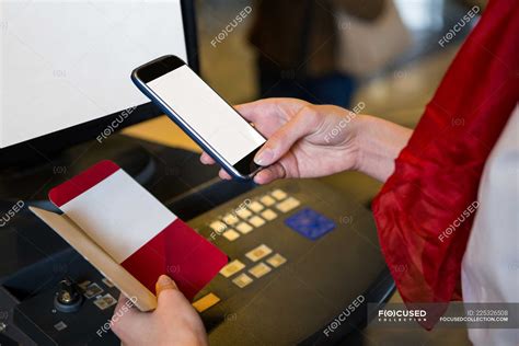 Close Up Of Female Scanning The Boarding Pass With Mobile Phone