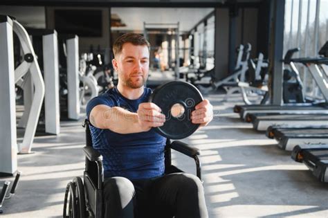 Wheelchair Athlete Lifting Weights In A Sunlit Park Gym Showcasing